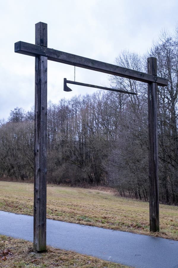 Wooden Hanging Beam with Axe Symbol in Nature Stock Image - Image of ...