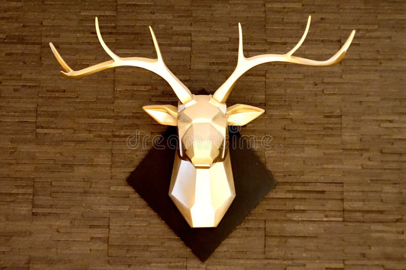 A Wooden Head on the Wall of a House with Two White Horns Stock Image ...
