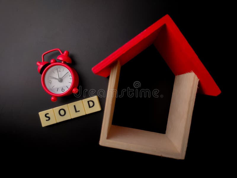 Wooden House and Clock with Word SOLD on Black Background Stock Image ...