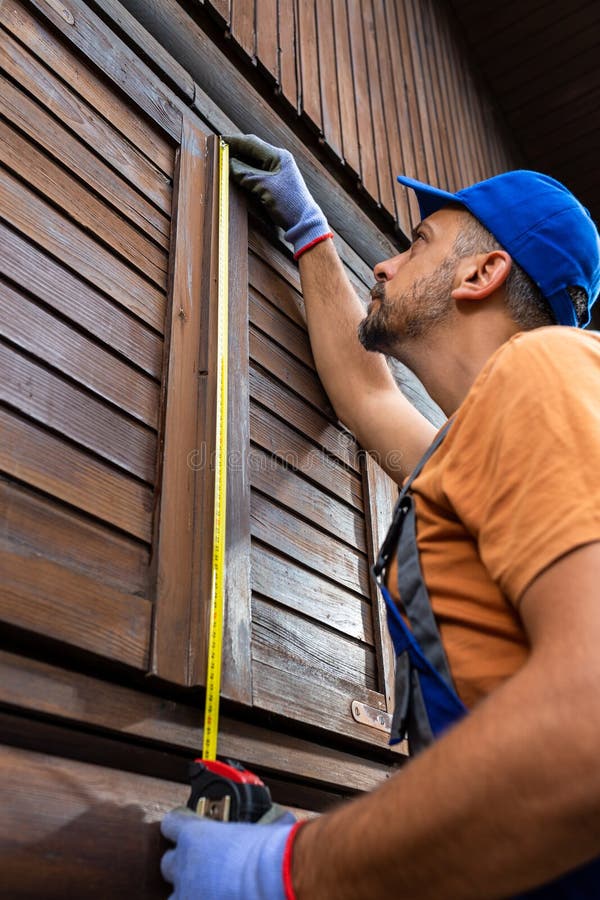 Wooden House Construction Worker Measuring Window Shutters Outdoors ...