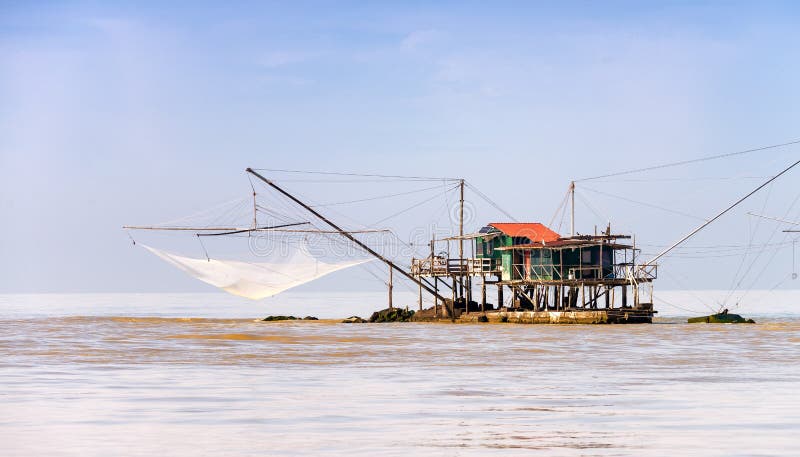 Wooden House in the Middle of the Sea Over Rocks Stock Photo - Image of ...