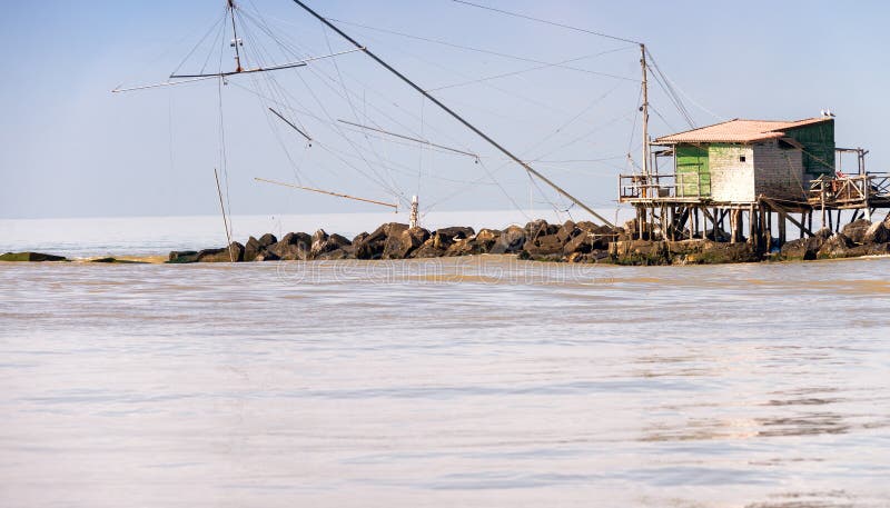 Wooden House in the Middle of the Sea Over Rocks Stock Photo - Image of ...