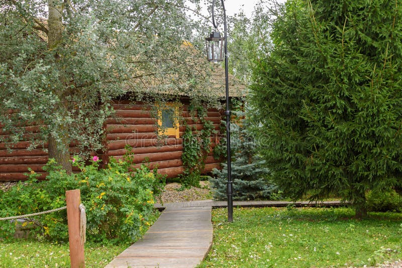 A Wooden House with a Path Surrounded by Trees in Summer. Stock Photo ...