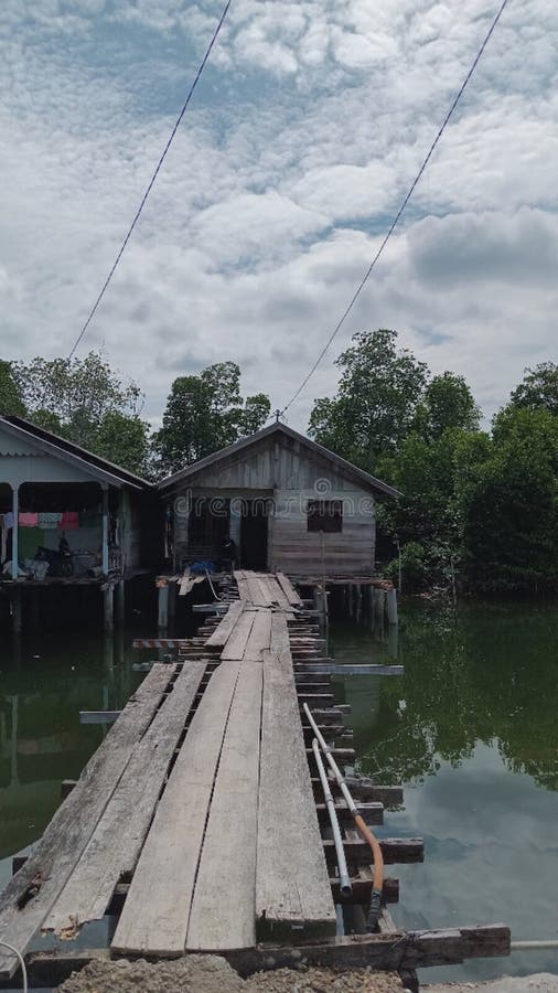 Wooden House by the River with a Rustic Bridge Stock Photo - Image of ...