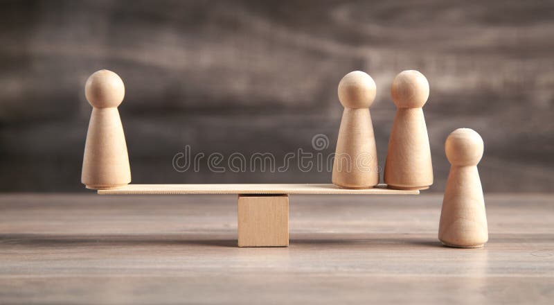 Wooden Human Figures on the Wooden Balance Stock Photo - Image of ...