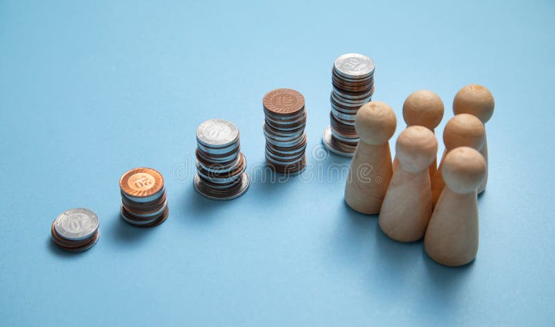 Wooden Human Figures with a Stack of Coins Stock Photo - Image of ...