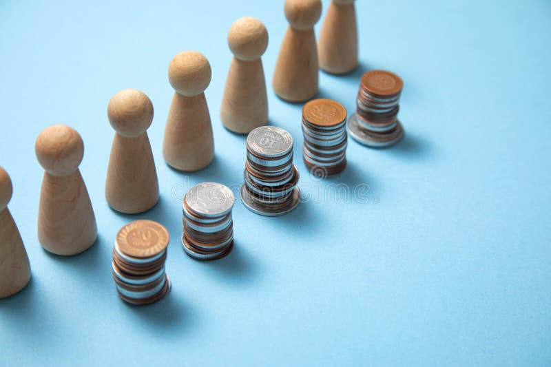 Wooden Human Figures with a Stack of Coins Stock Photo - Image of ...