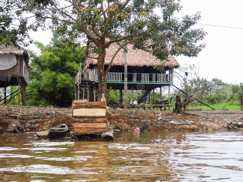 Wooden Hut Overlooking Polluted River in the Amazon Rainforest, Peru ...