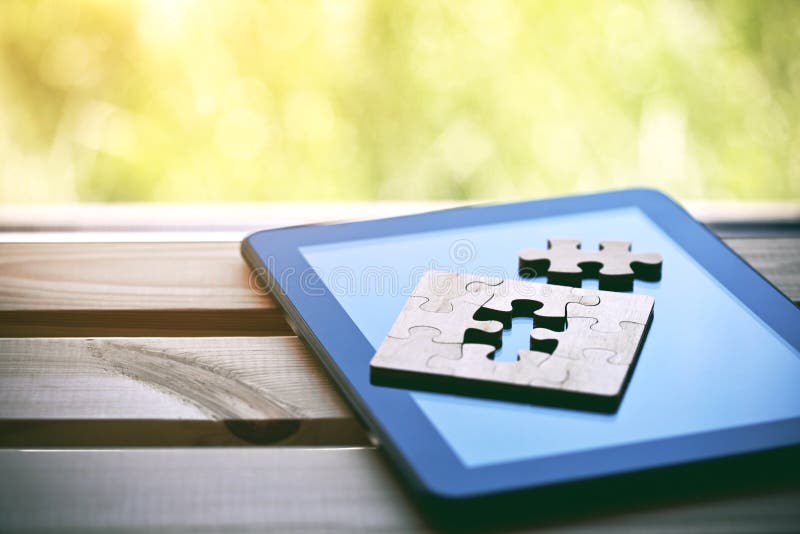 Wooden Jigsaw Puzzle with Tablet Computer Stock Photo - Image of wooden ...
