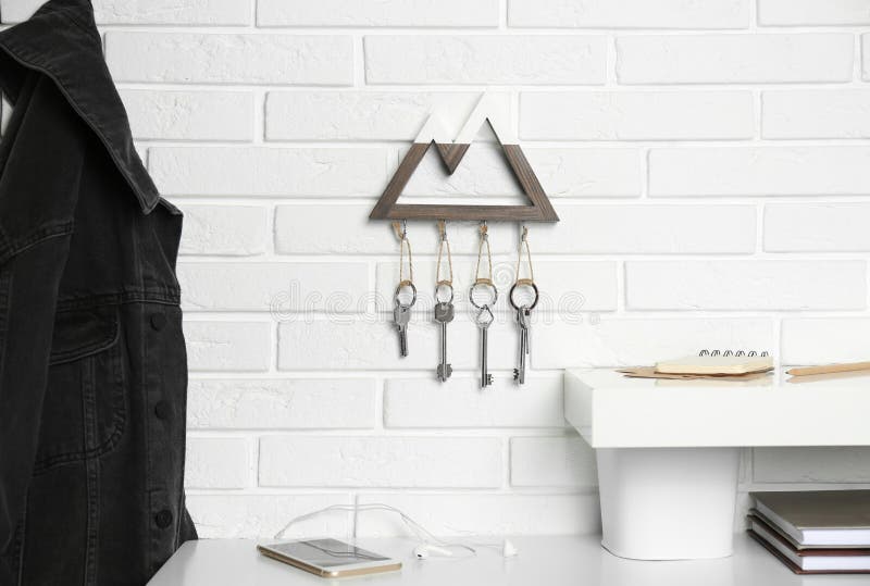 Wooden Key Holder on White Brick Wall Stock Image - Image of group ...