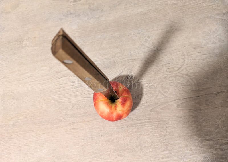 Wooden Knife Cuts into the Apple from the Top in the Middle Stock Photo ...