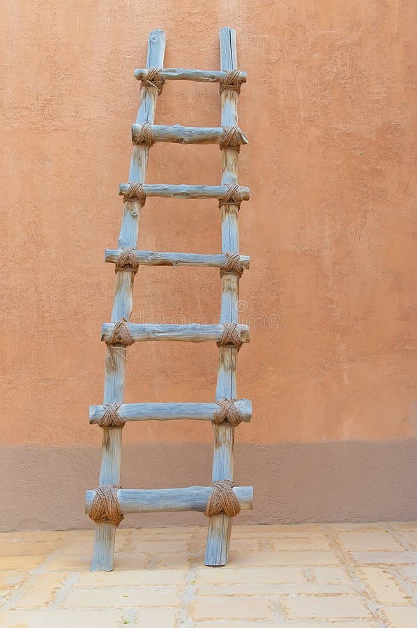 An Old Building With Damaged Facade With Wooden Ladder By The Wall ...