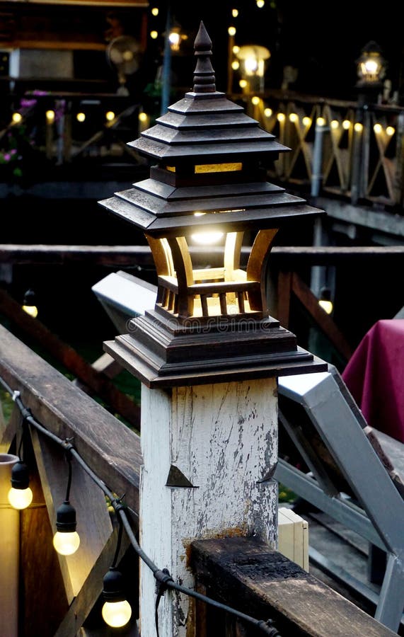 Wooden Lantern in Thai Style with Light Bulb at Baluster Stock Photo ...