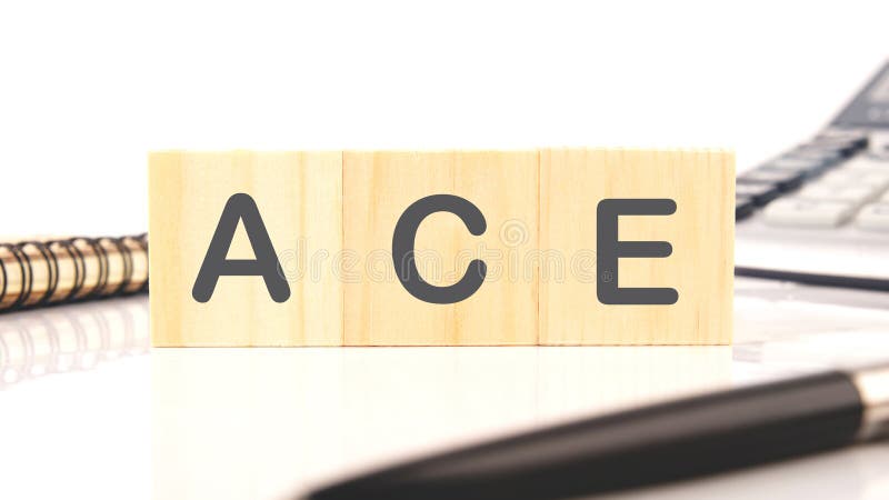 Wooden Letter Blocks Spell ACE on a Desk that Includes a Notebook and a ...