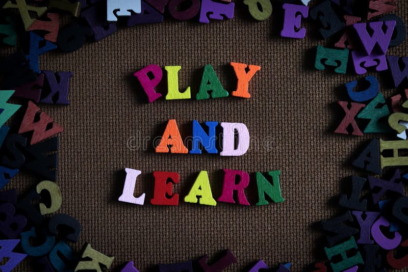 Wooden Letters Spelling `Play and Learn` Stock Photo - Image of games ...