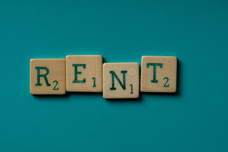Wooden Letters Spelling the Word "rent" on a Blue Background Stock ...