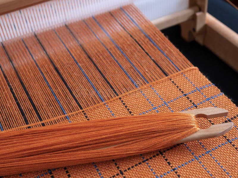 Wooden Loom with Shuttle and Woven Orange Textile with Striped Pattern ...