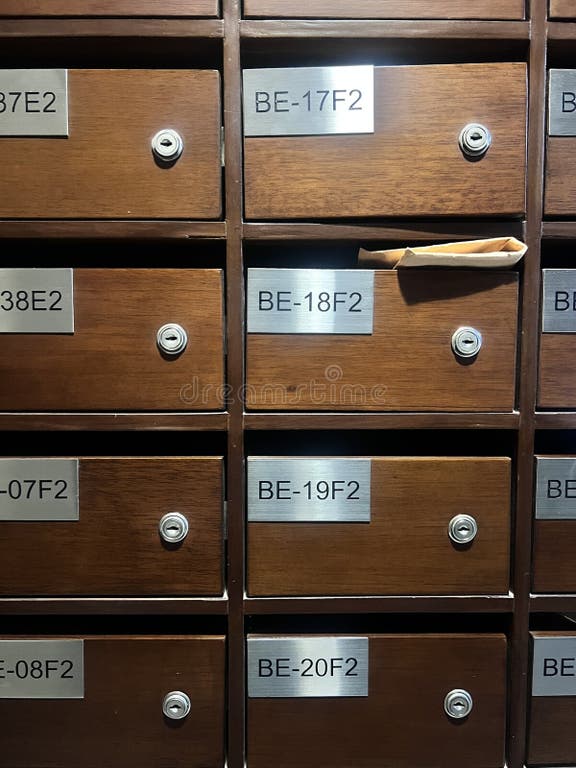 Modern Wooden Brown Mailboxes with Numbers in the Lobby of a ...