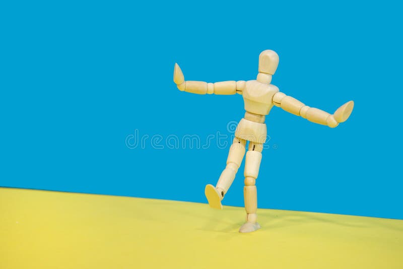Wooden Mannequin Posing Over Yellow and Blue Background Stock Image ...