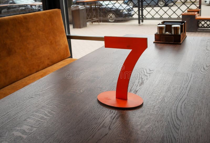 The Wooden Number Seven is on the Table. Table Number 7 in a Cafe or ...