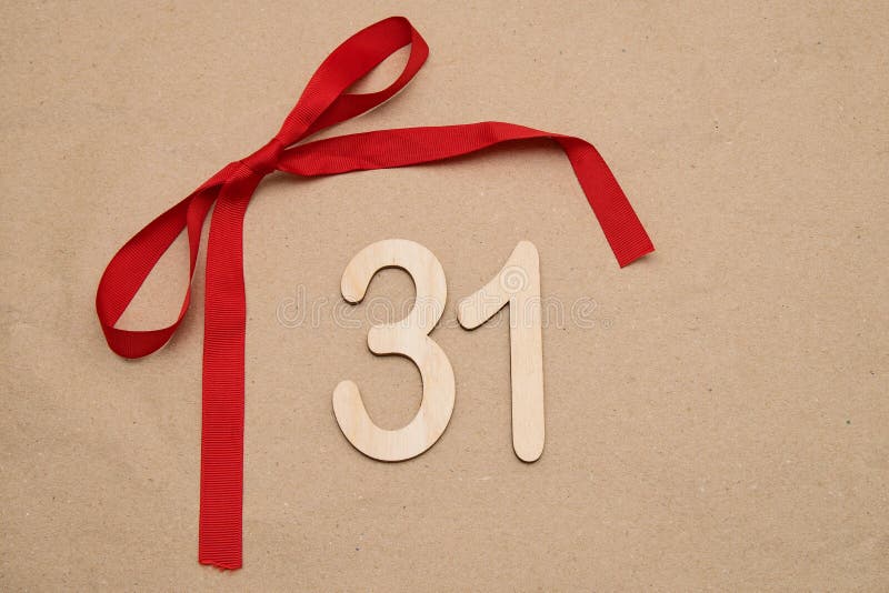 Light Wooden Numbers 31 Lie on Craft Paper with a Red Bow Stock Photo ...