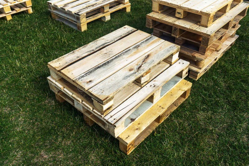 Wooden Pallets on a Green Lawn. Close-up Stock Image - Image of ...