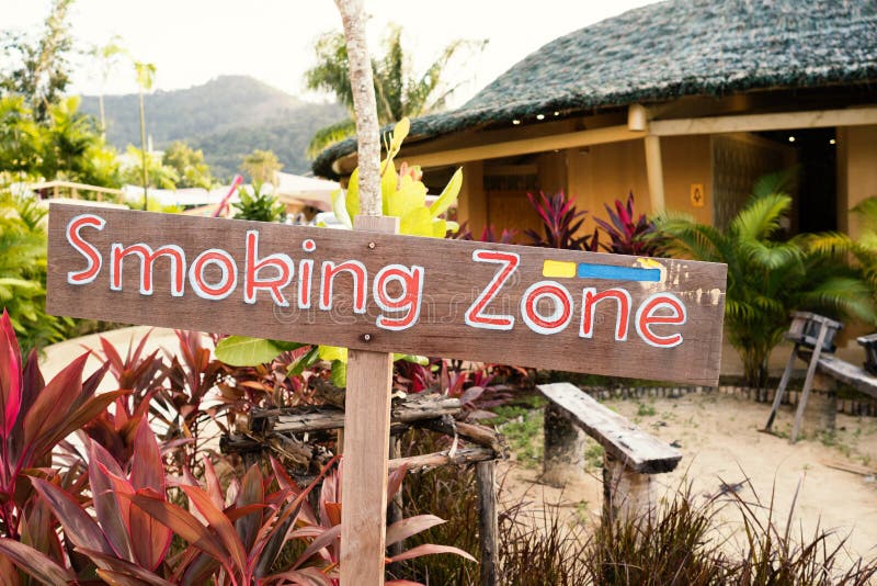 Wooden Panel with Text Smoking Zone at Park with Tropical Plants. Area ...