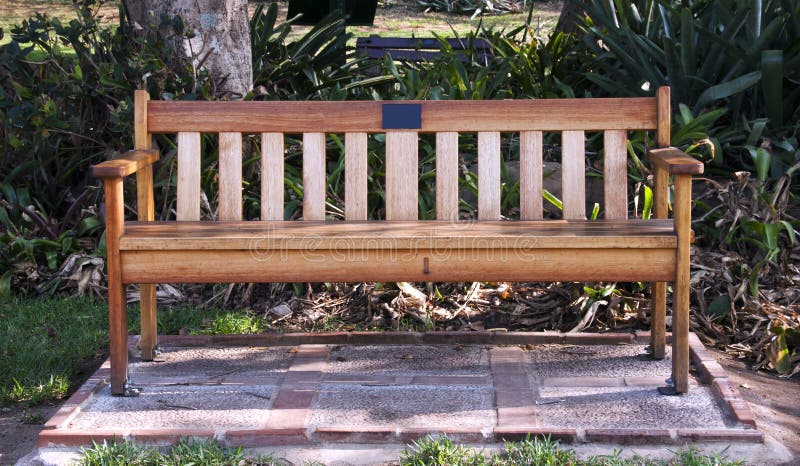 Wooden Park Bench in Shaded Garden Setting Stock Photo - Image of ...