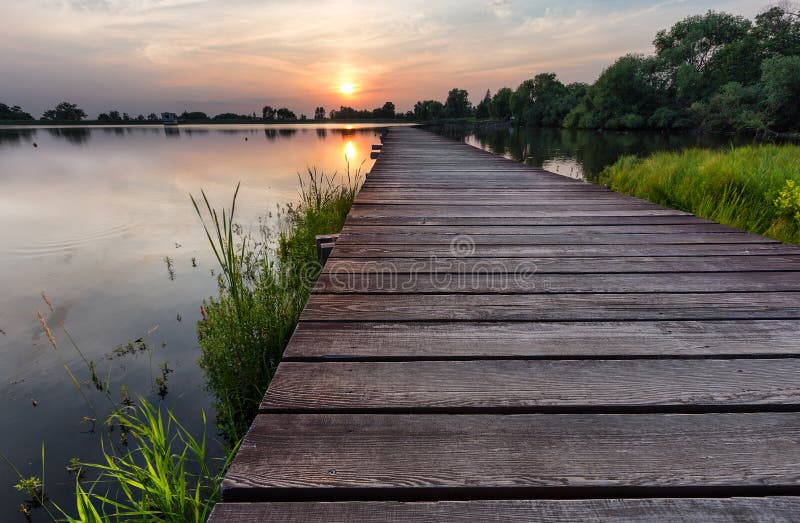 Wooden Path Over the Lake at Sunset Stock Image - Image of perspective ...