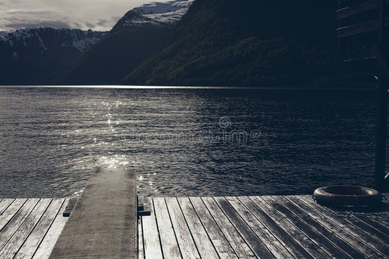 Wooden Path Over the Water of a Lake with Snowy Mountains Stock Image ...