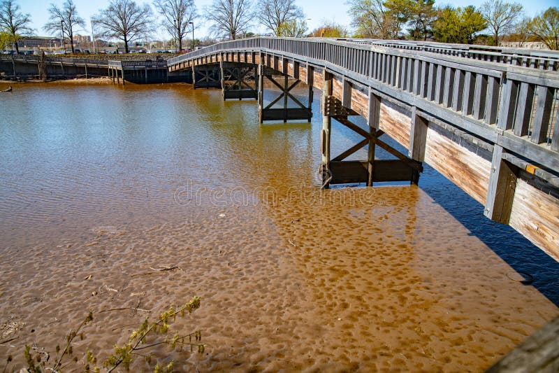 Wooden Pedestrian Bridge with Railings Over a Shallow River Stock Photo ...