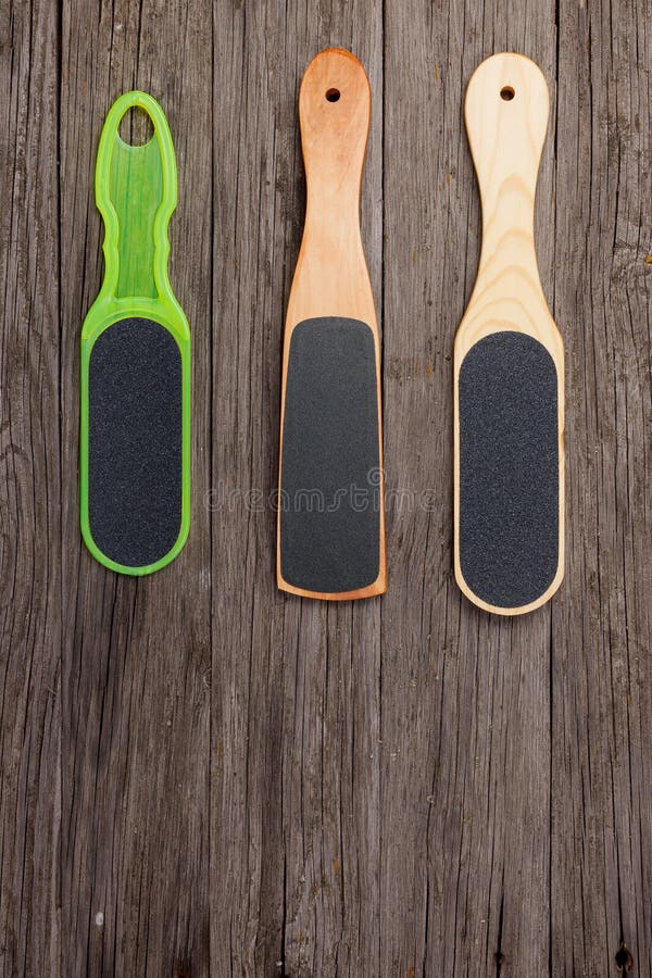 Wooden Pedicure Graters and a Plastic Foot File on Wooden Boards Stock ...