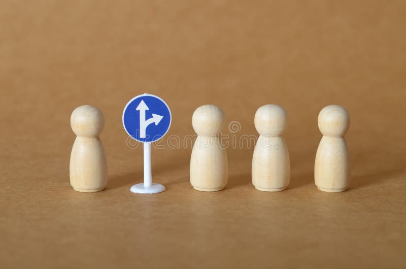 Wooden Peg Figures Facing a Decision Point with Directional Sign Stock ...