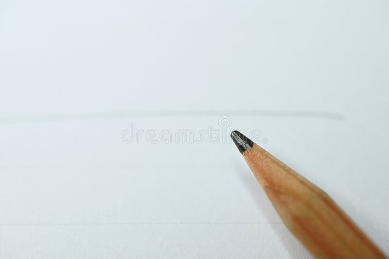 Close Up Sharp Brown Wooden Pencil on White Paper Stock Image - Image ...