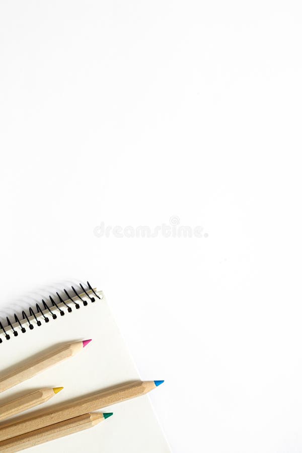 Wooden Pencils of Different Colors and a Notebook on a White Background ...