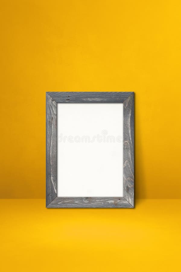 Wooden Picture Frame Leaning on a Yellow Wall Stock Photo - Image of ...