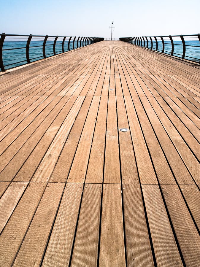 Wooden Pier or Jetty and a Boat on a Lake Sunset. Versilia Tuscany ...