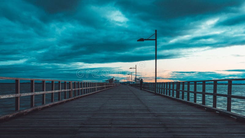 Wooden Pier Along Sea with Blue Clouds at Sunset Sky Stock Image ...