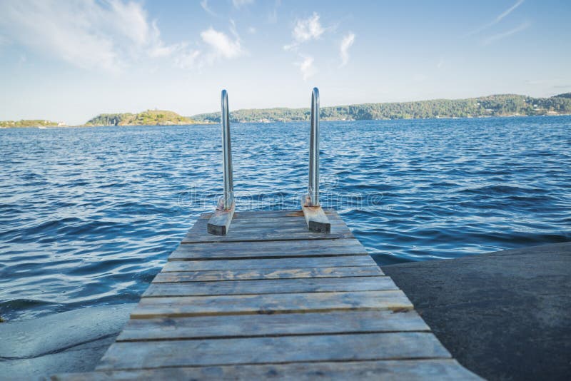 Wooden Pier on the Deep Blue Water Stock Image - Image of vacation ...