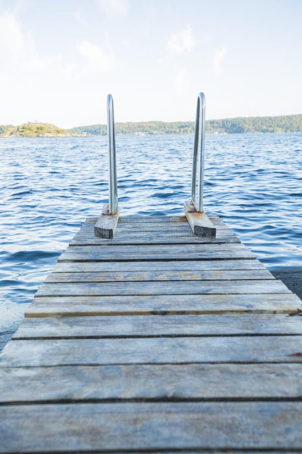 Wooden Pier on the Deep Blue Water Stock Image - Image of dock ...