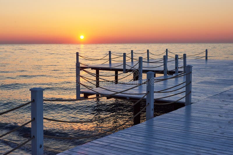 Wooden Pier on a Fancy Orange Sunset. Stock Photo - Image of rays, pier ...