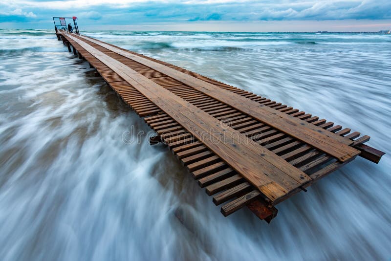 Wooden Pier in a Storm Covered with a Wave, Long Exposure Stock Image ...