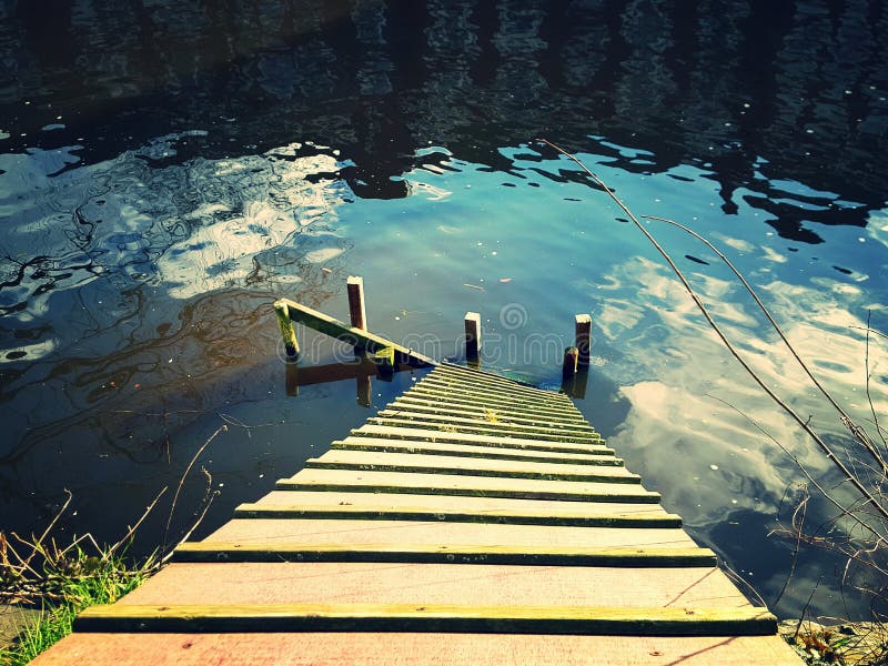 Wooden pier in water stock photo. Image of waves, water - 67687084