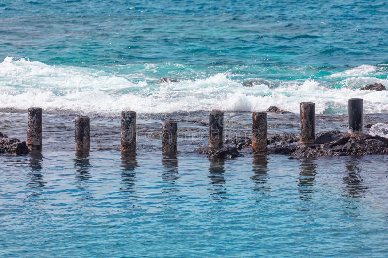 Wooden pillars breakwaters stock image. Image of seascape - 294005407