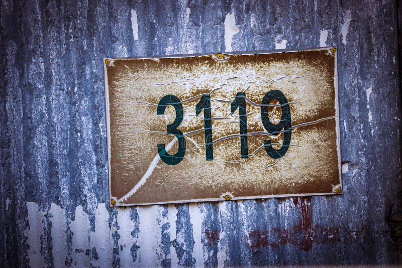 Wooden Plaque with Numbers on a Tin Wall Stock Photo - Image of plaque ...