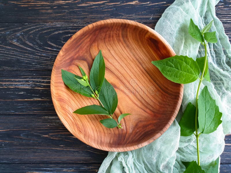 Wooden Plate, Green Branch Design on Wooden Background Stock Photo ...