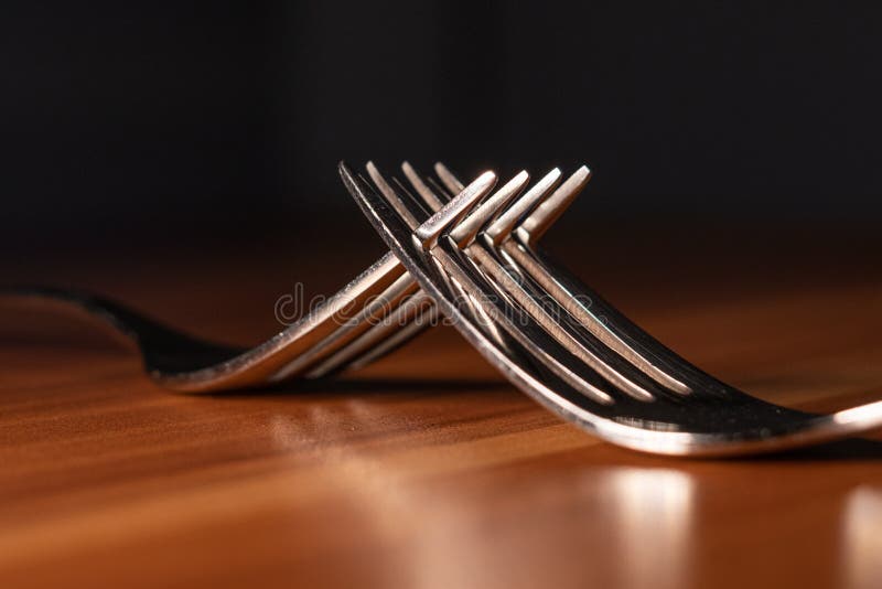On a Wooden Plate 2 Silver Forks are Inserted into Each Other Stock ...