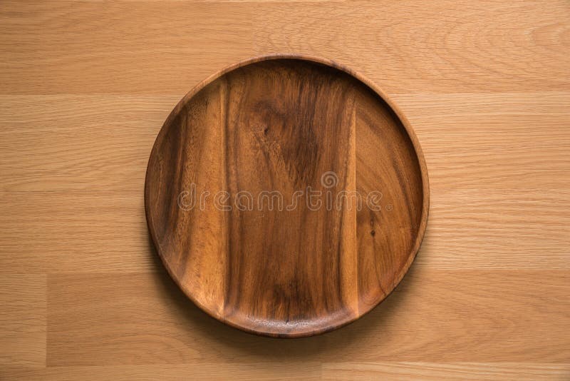 Wooden plate on table stock photo. Image of bowl, plate - 117740018
