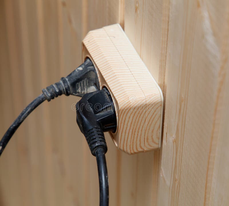 A Wooden Plug Box with Two Outlets and a Black Cord Plugged into it ...