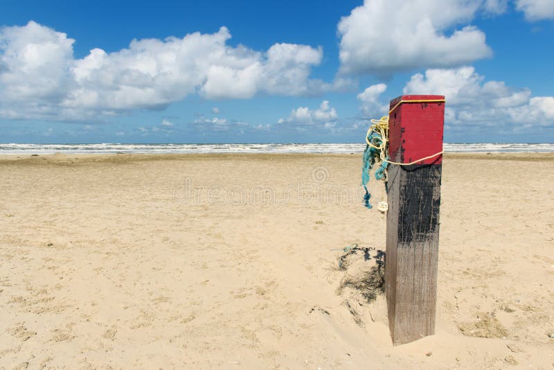 Wooden pole at the beach stock photo. Image of netherlands - 41847434